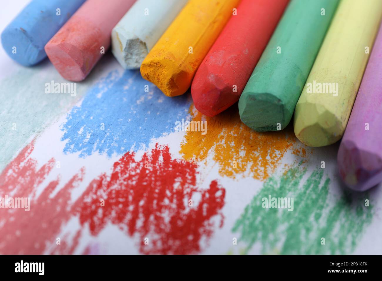 Colorful pastel chalks and scribbles on white background, closeup ...