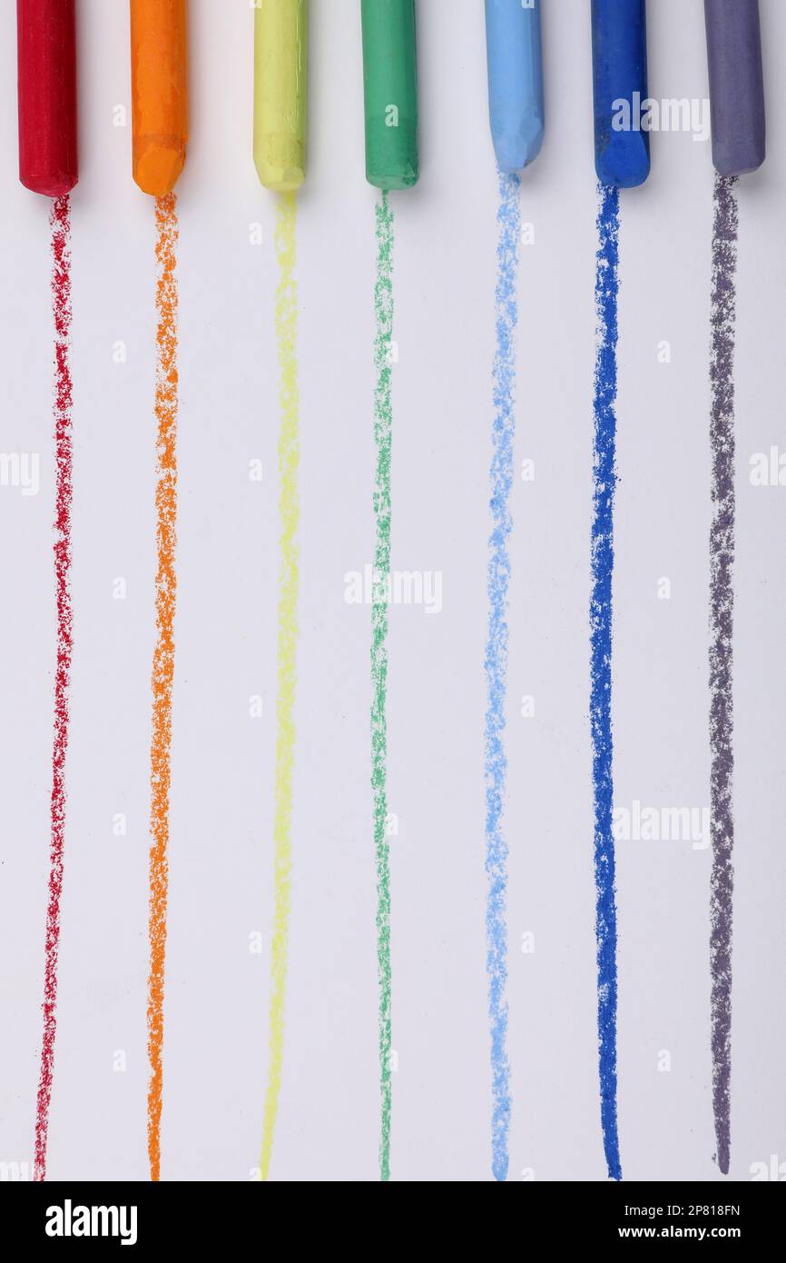 Colorful pastel chalks and lines on white background, flat lay. Drawing ...