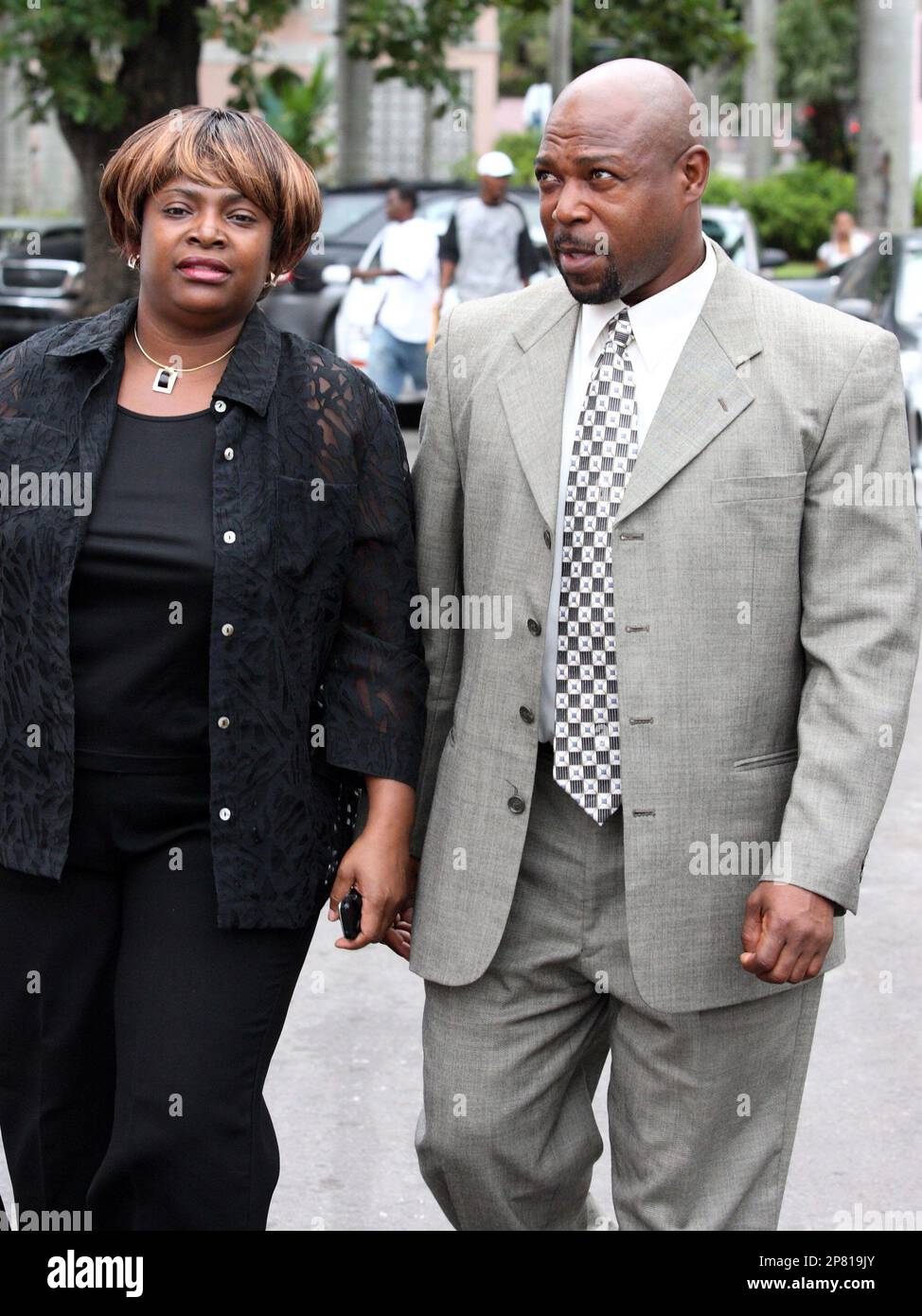 Bahamas' paramedic Tarino Lightbourne, right, arrives accompanied by an ...