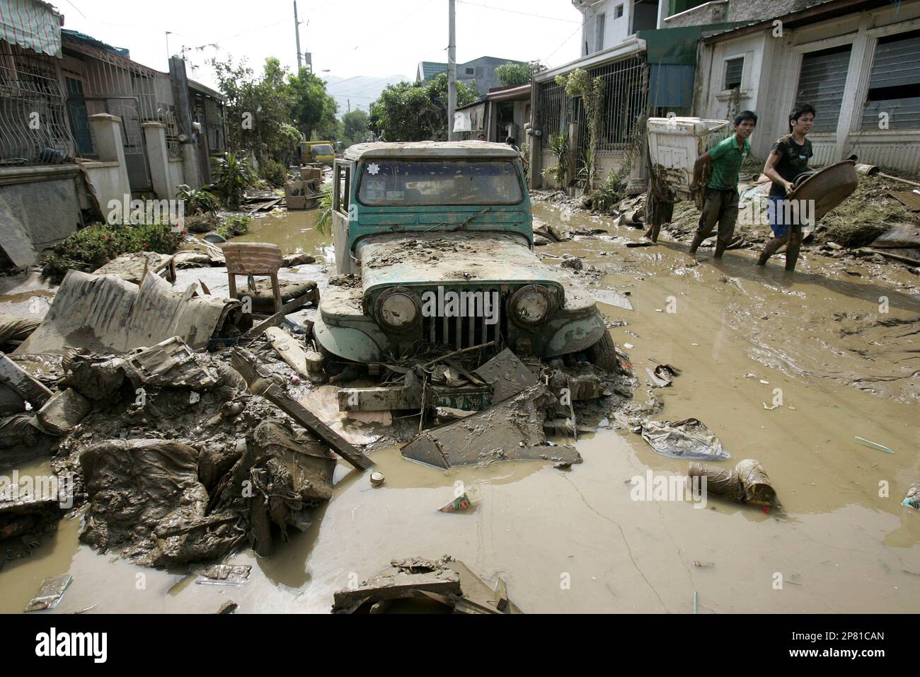 Residents salvage their belongings from their houses at a storm-ravaged ...