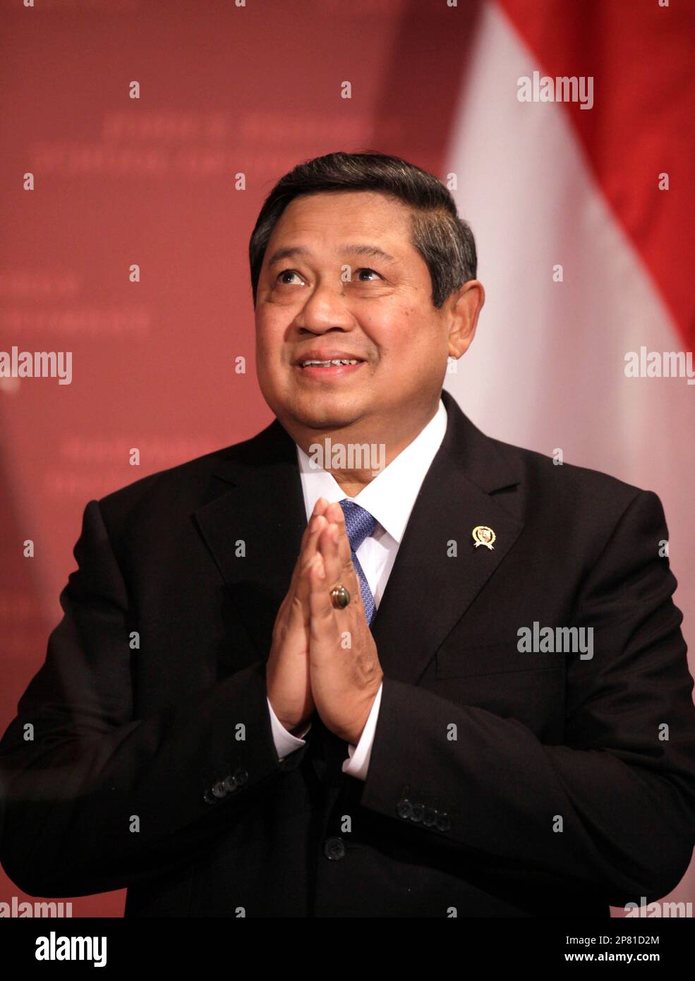 Indonesian President Susilo Bambang Yudhoyono places his hands together ...