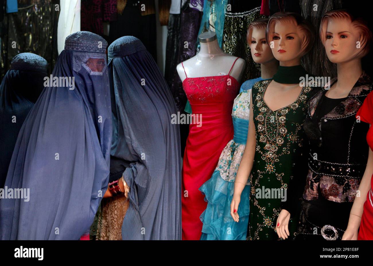 Burqa clad Afghan women shop in Kabul, Afghanistan, Tuesday, Sept. 29 ...