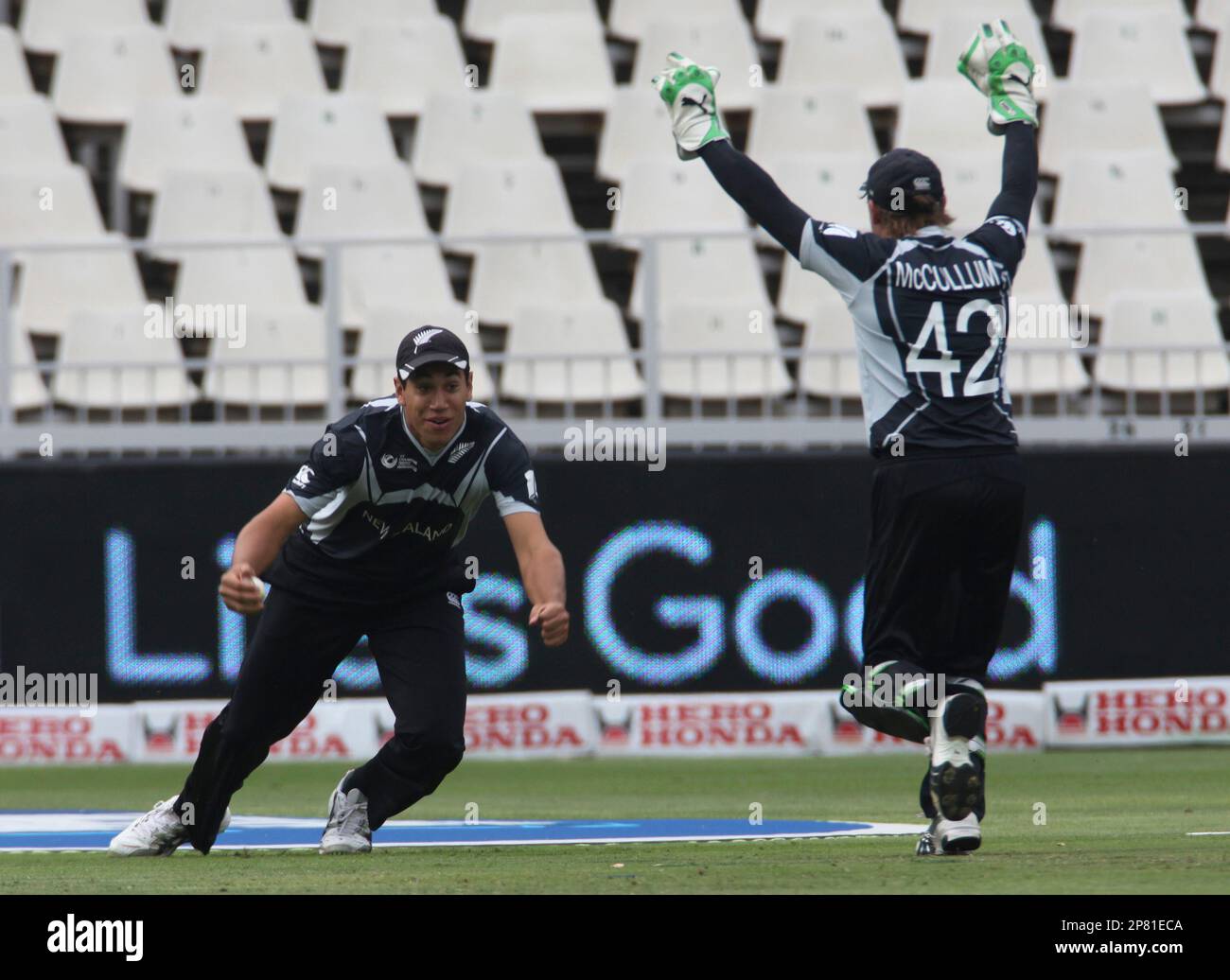 New Zealand fielder Ross Taylor, left is congratulated by New Zealand ...