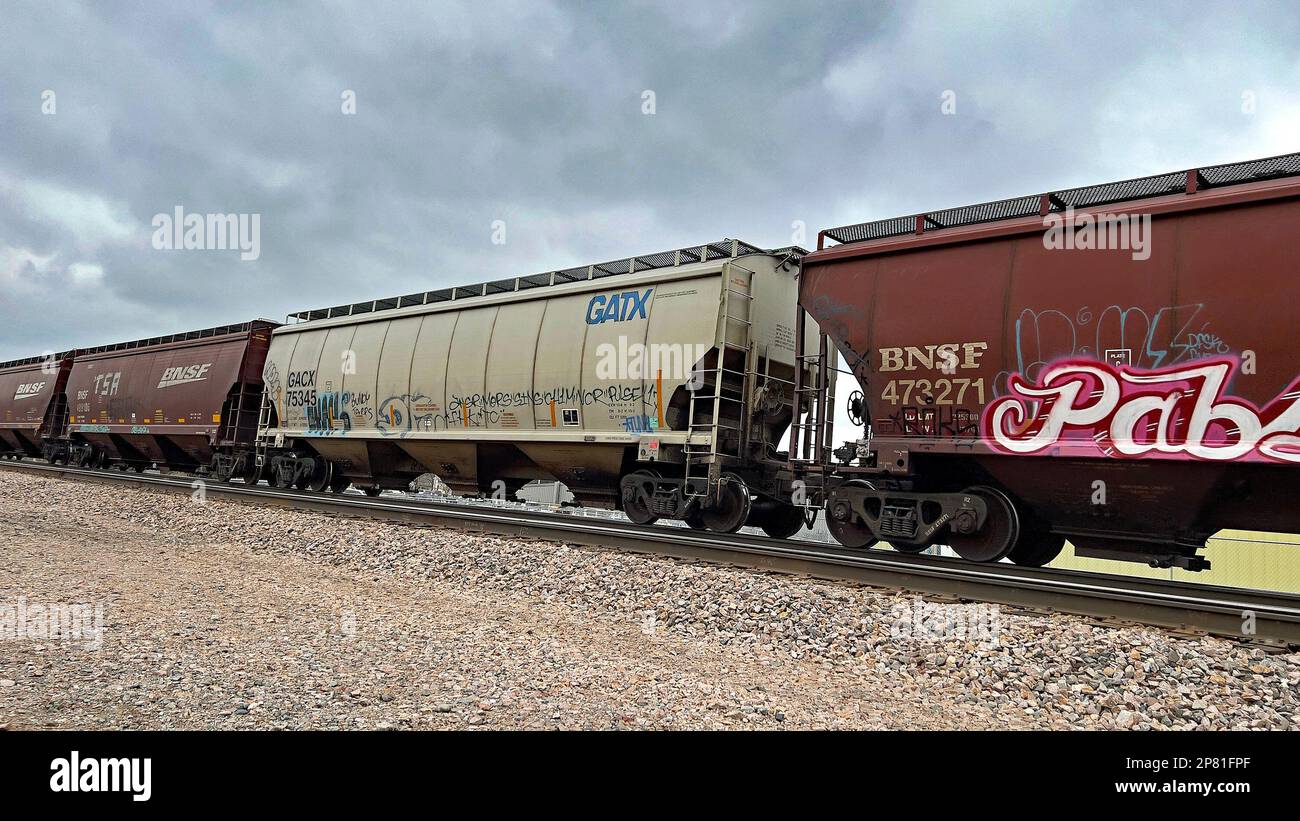 EMPORIA, KANSAS - MARCH 8, 2023 A BNSF freight train hauling grain hopper cars used to transport ...