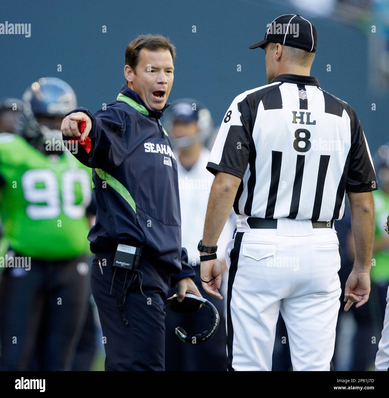 Seattle Seahawks coach Jim Mora confers with head linesman Dana ...