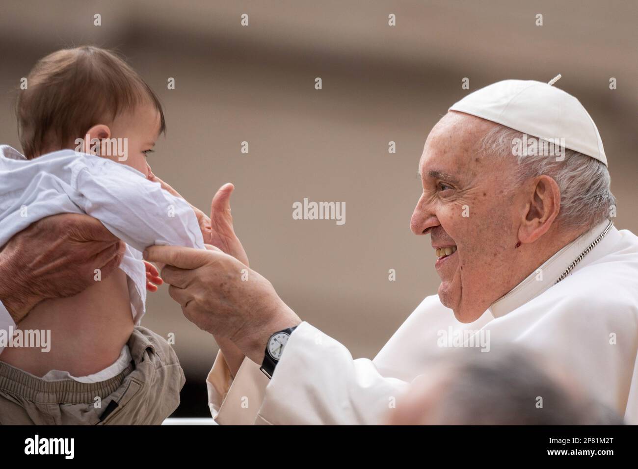 Pope Francis greets and blesses a child during his traditional ...