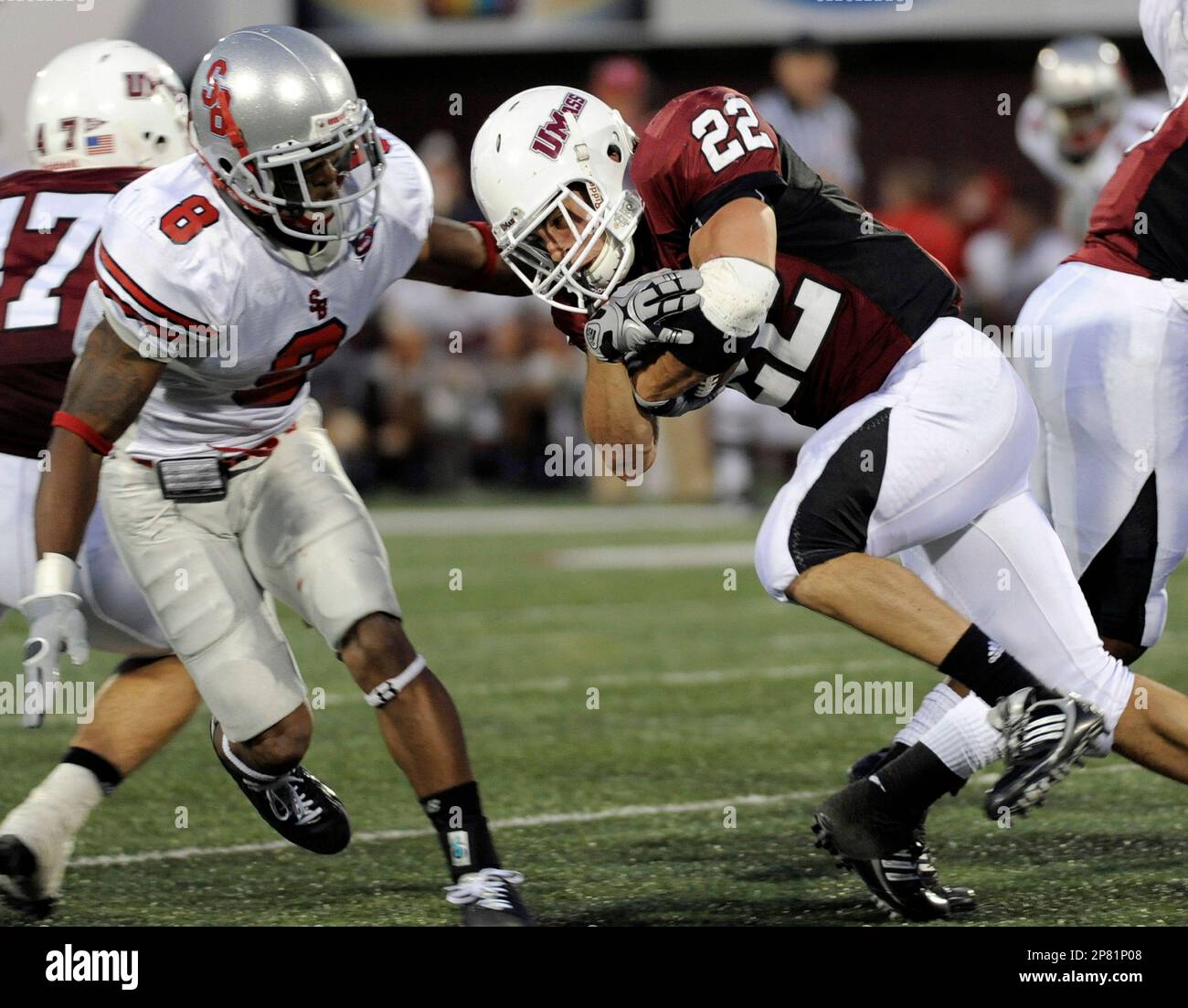 Massachusetts' Jonathan Hernandez (22) drives into Stony Brook defender ...