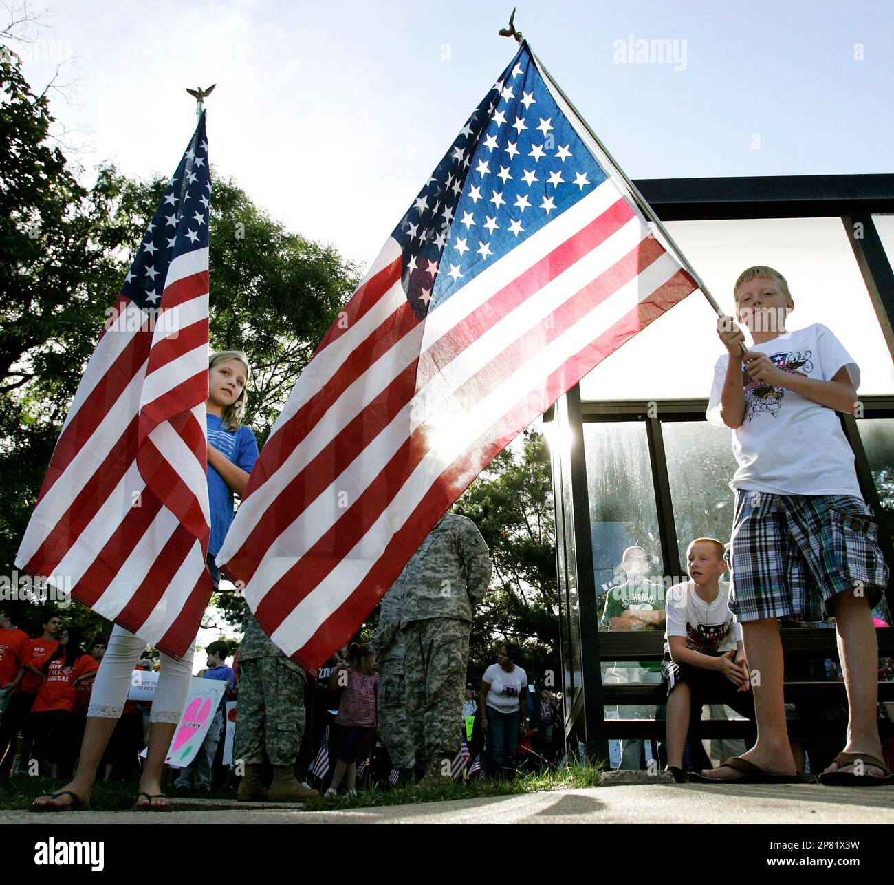 Kenny Fowler, 13, and sister Alicia Fowler, 10, of Smyrna, Del., wait ...