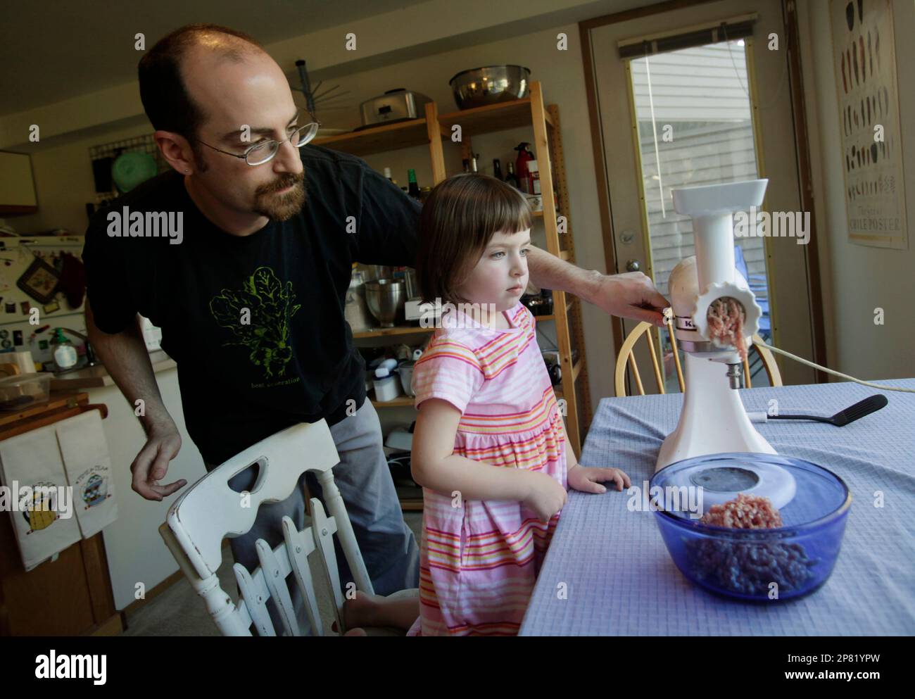 FILE- This April 6, 2009 file photo shows Matthew Amster-Burton helping ...