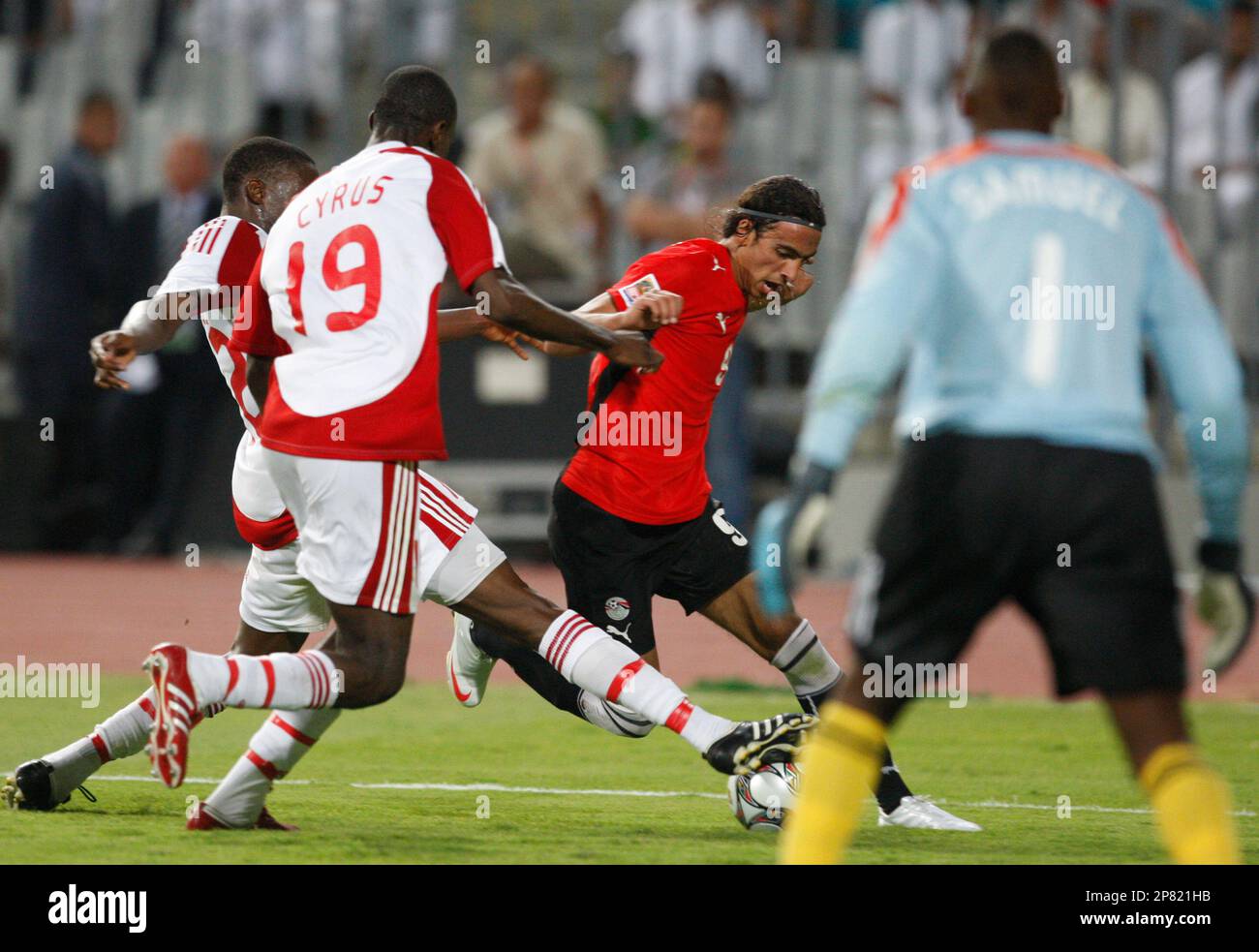 Egypt's Mohamed Talaat, second right tries to pass Trinidad and Tobago ...