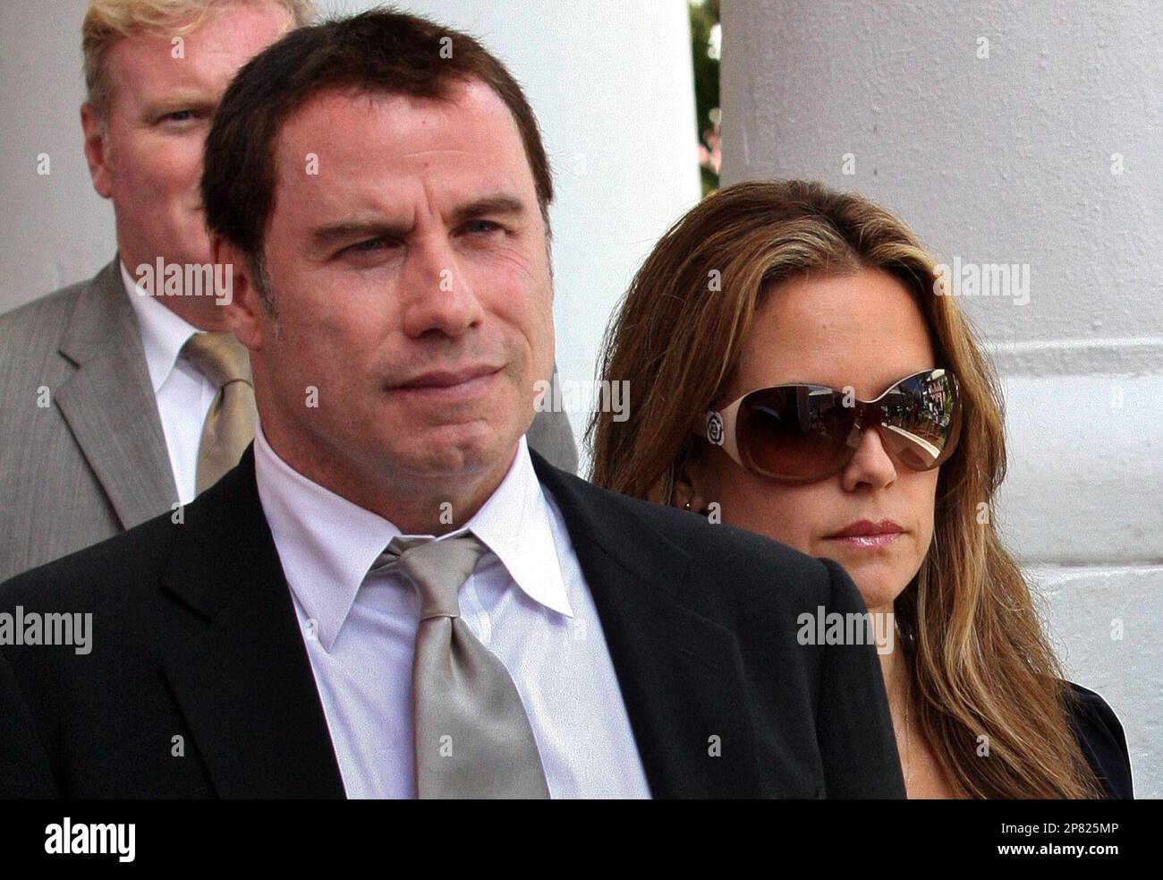 U.S. actor John Travolta and wife Kelly Preston leave the court ...