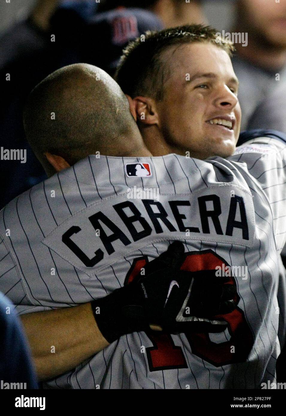 Minnesota Twins' Matt Tolbert is hugged by Orlando Cabrera after ...