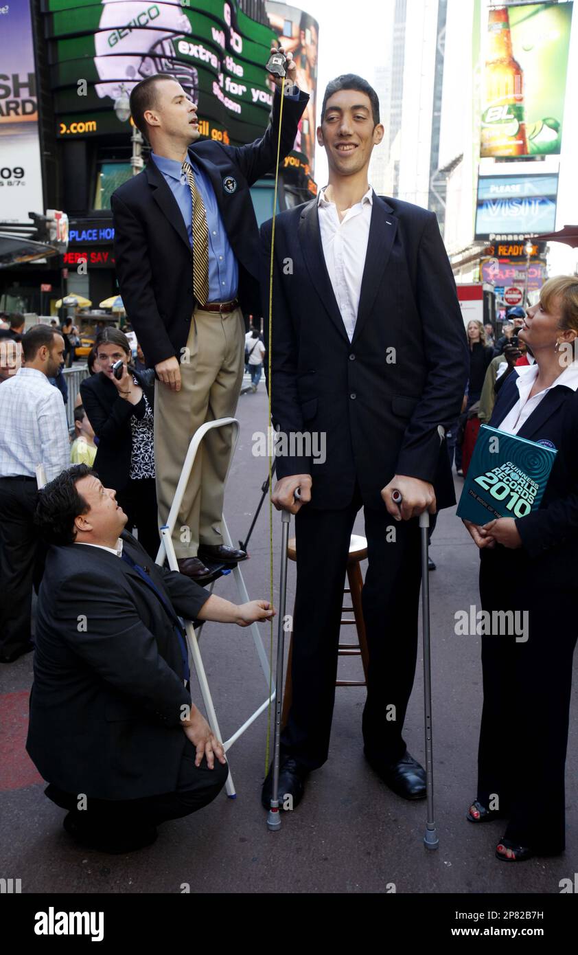 The world's tallest man, Sultan Kosen of Turkey, is measured by ...