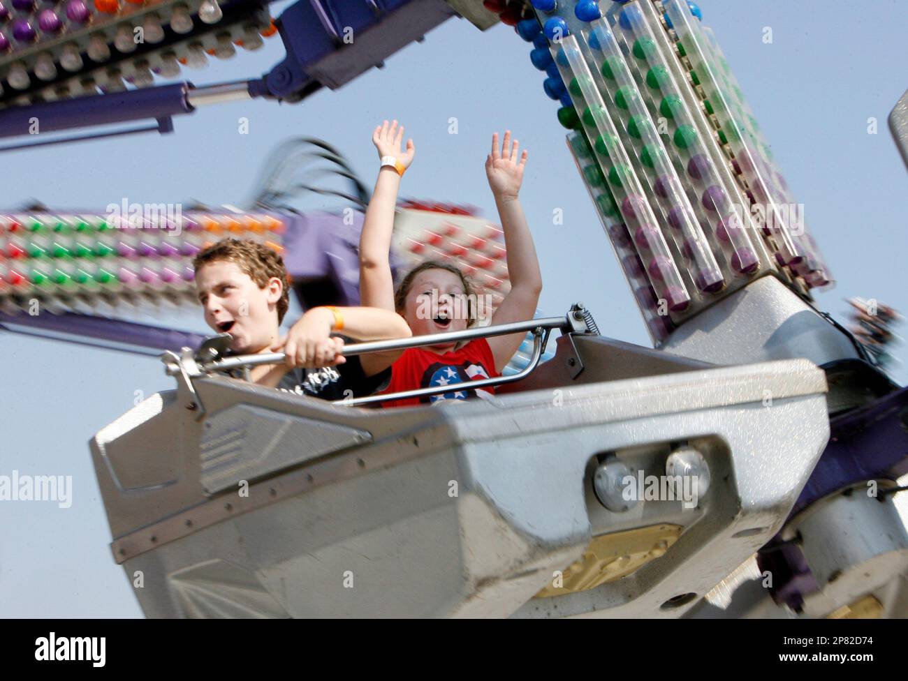 Dylan Smith, 11, and his sister Lydia Smith, 10, ride the Orbiter at ...
