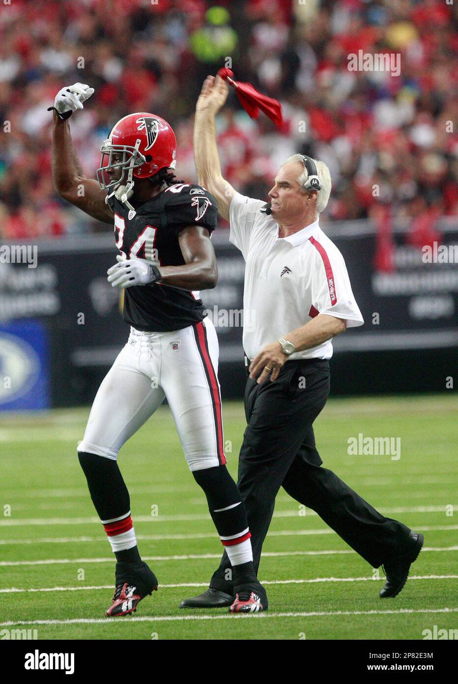 Atlanta Falcons coach Mike Smith, right, throws the red challenge flag ...