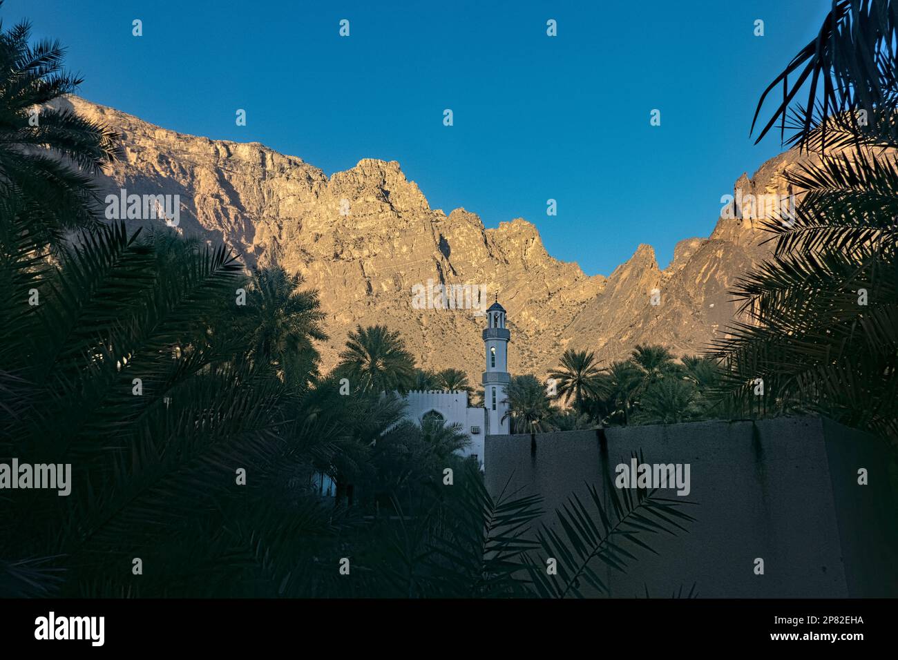 The Western Hajar mountains rise above the mosque in Bald Sayt (Balad ...