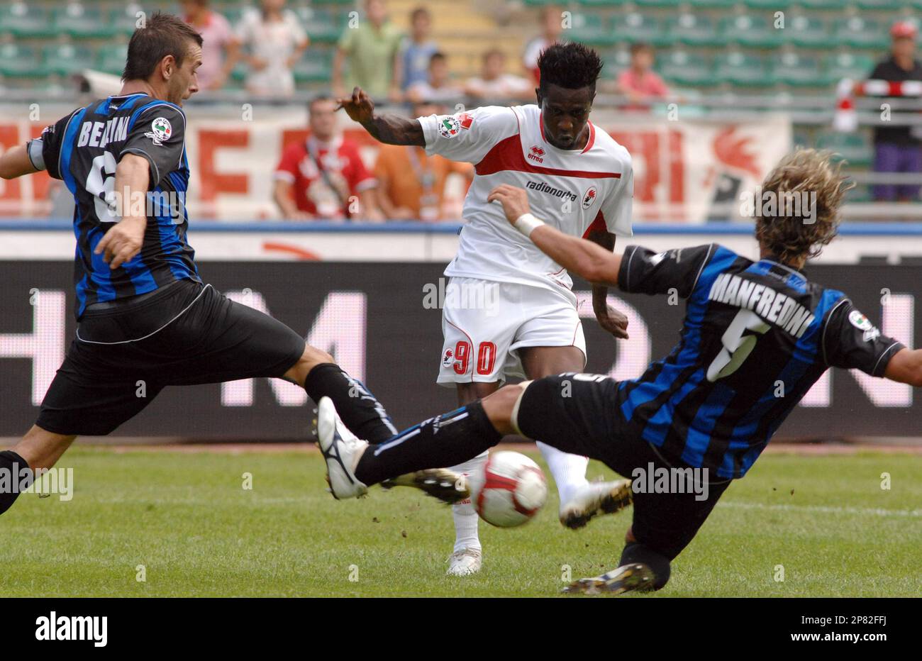Bari's Edgar Alvarez, in white at center, is pressed by Atalanta's ...