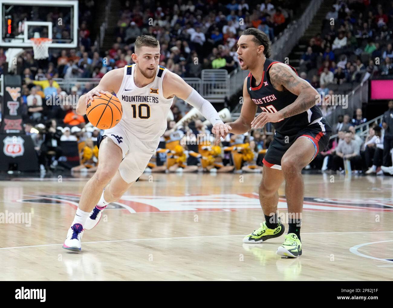 MAR 08 2023: West Virginia guard Erik Stevenson (10) drives on Texas ...