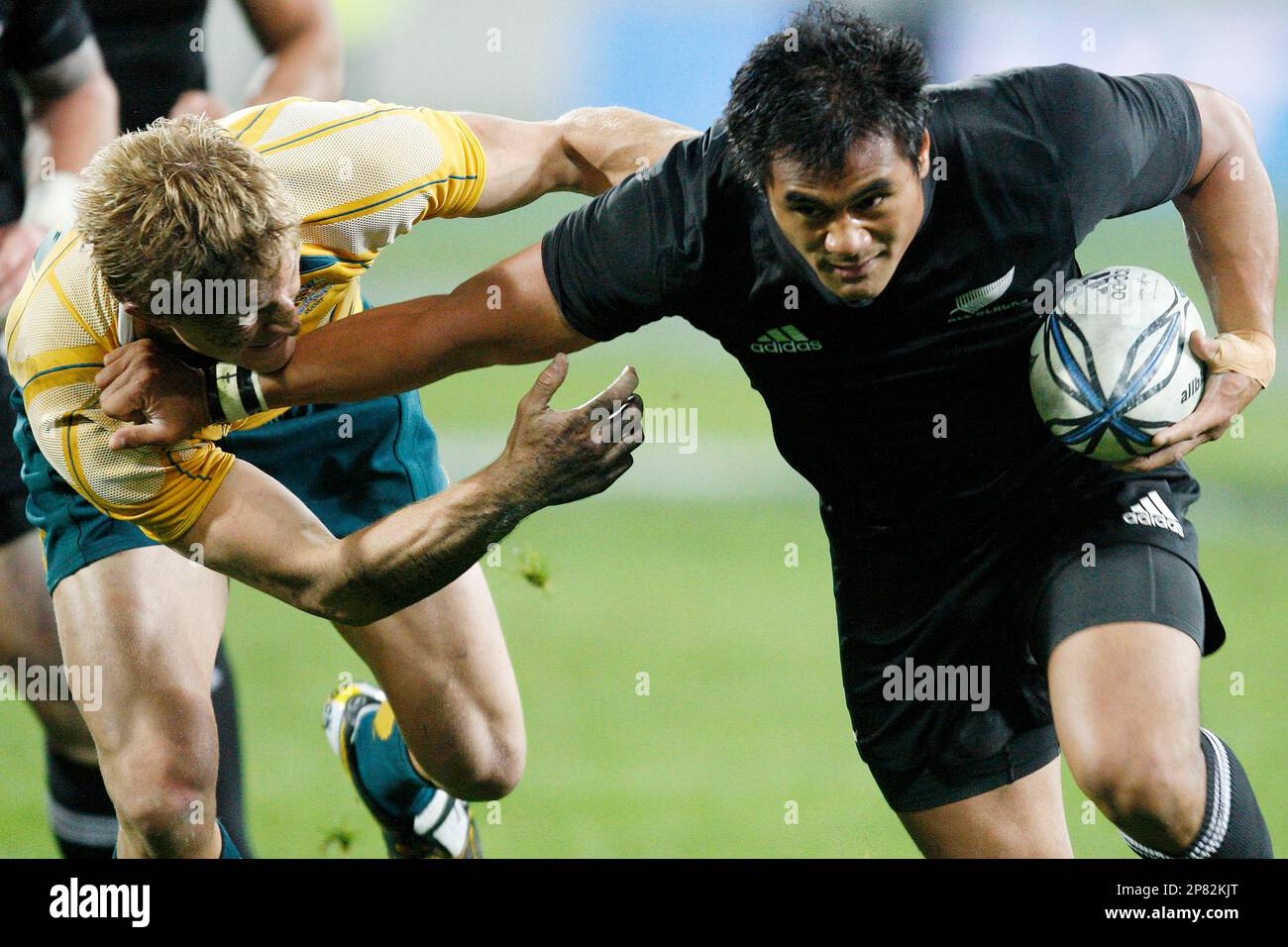New Zealand's Isaia Toeava, right, tries to fend off Australia's Lachie ...