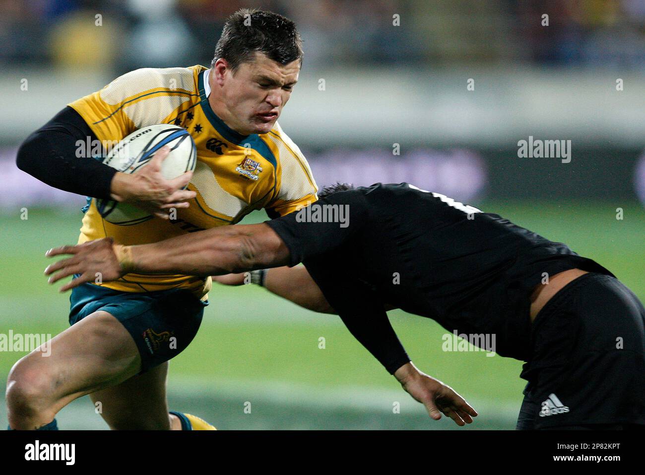 Australia's Adam Ashley-Cooper, left, looks to fend off the tackle of ...