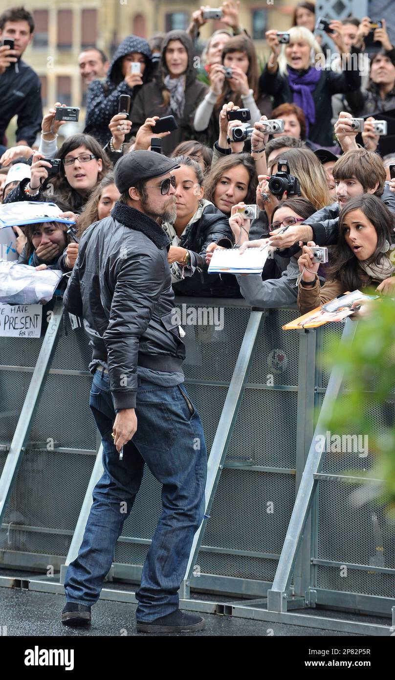 USA actor Brad Pitt prepares to sign autographs for fans as he arrives ...