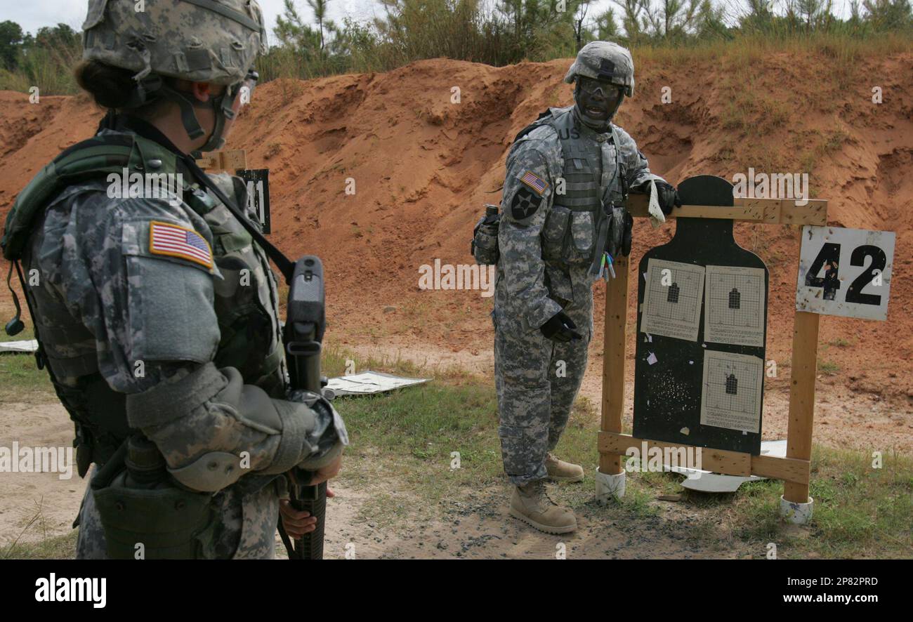 Staff Sgt. Jamie Jones, right, stands over the target as he instructs ...