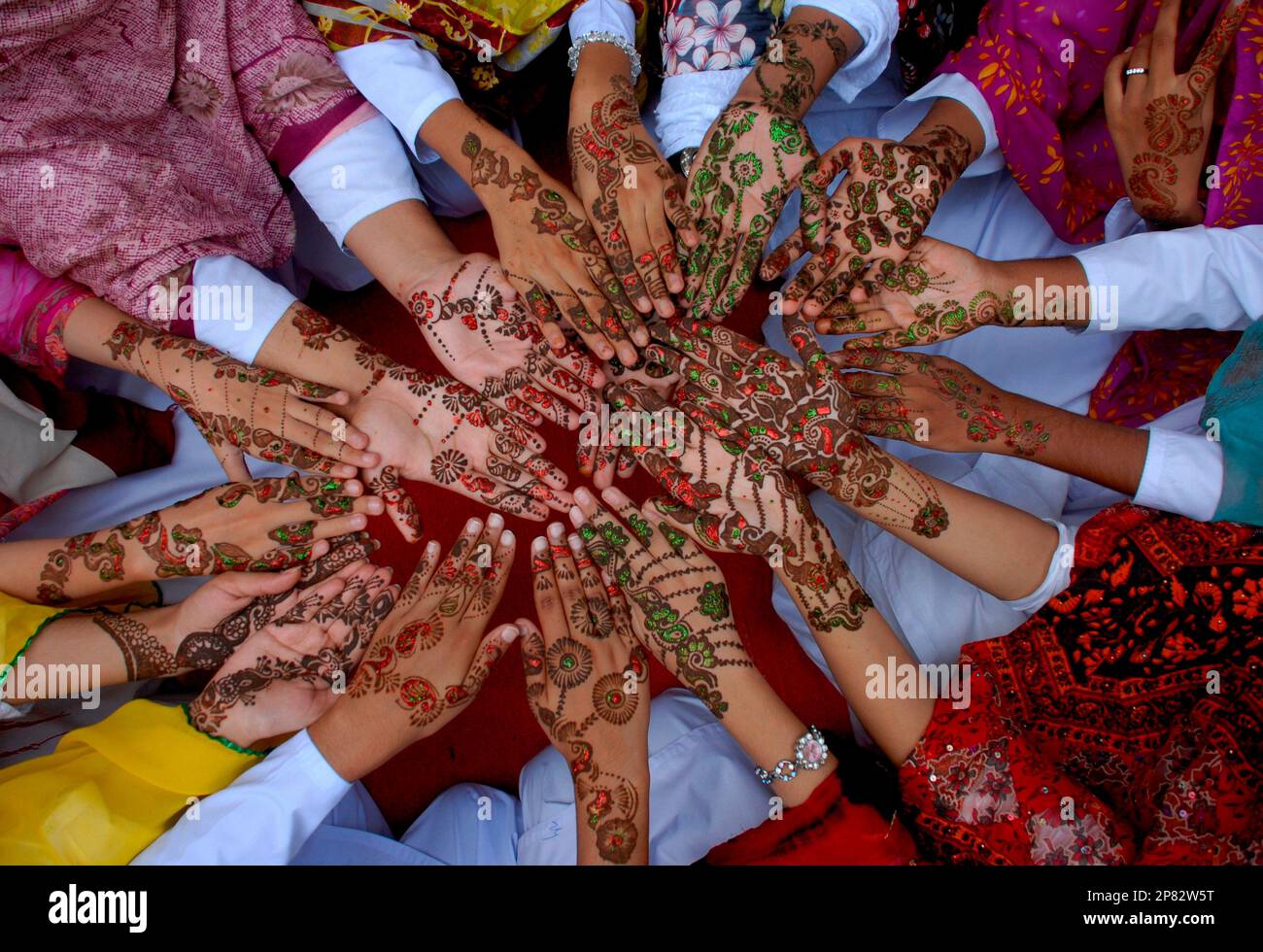 Pakistani girls display their hands decorated with Mehndi or henna in ...