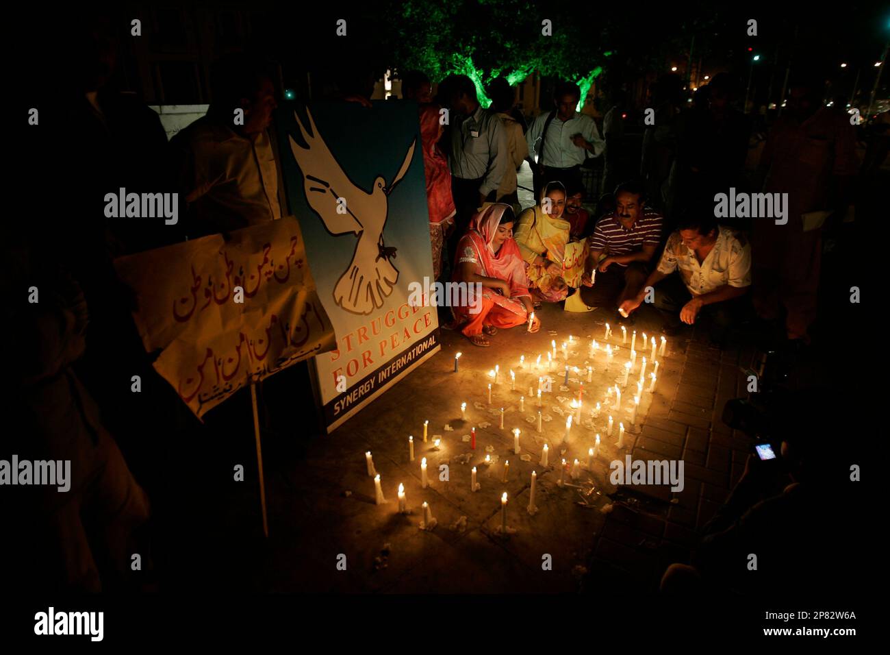 Pakistani human rights activists light candles in remembrance of ...