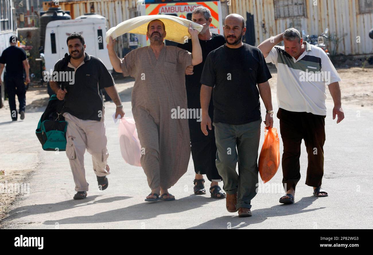 Released Palestinian prisoners walk out of a Hamas prison in Gaza City ...