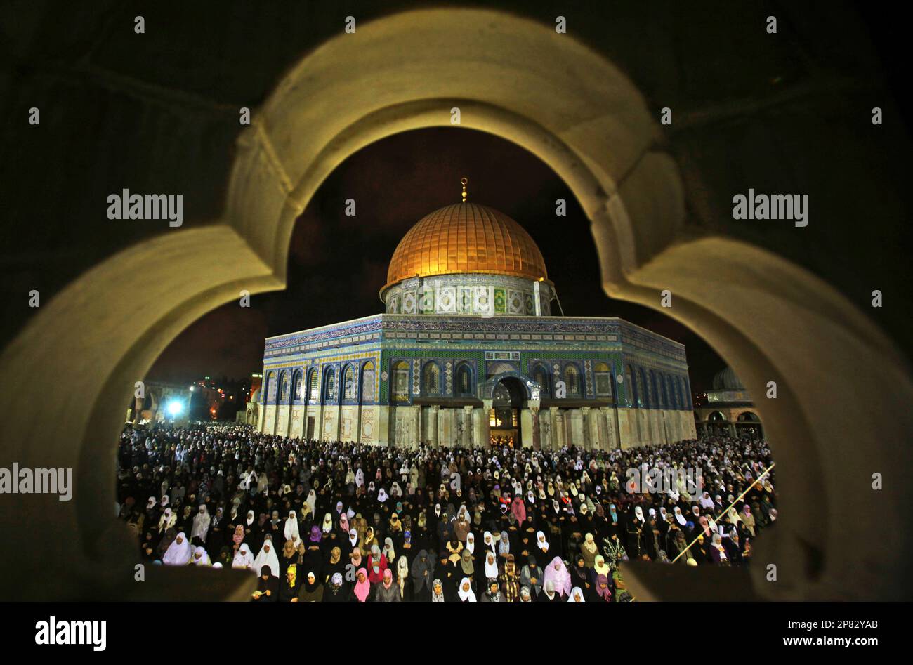 Palestinian Muslim worshipers pray during Lilat al-Qader, also known as ...