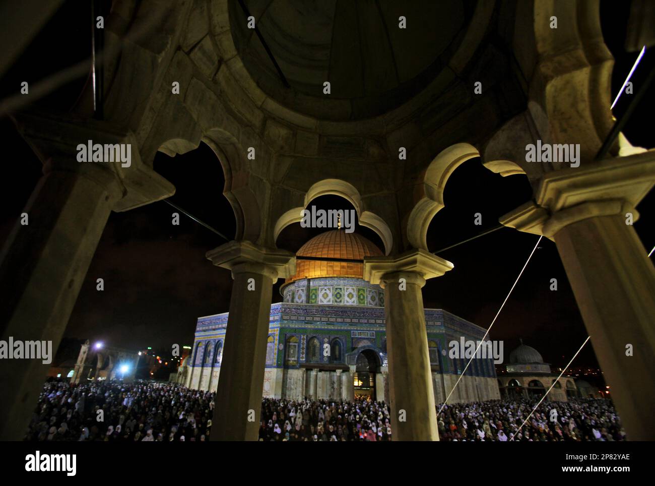 Palestinian Muslim worshipers pray during Lilat al-Qader, also known as ...