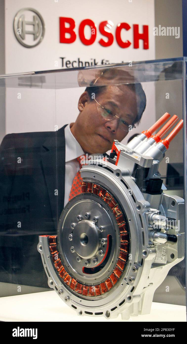A visitor inspects a model of an electric engine of Bosch on the second ...