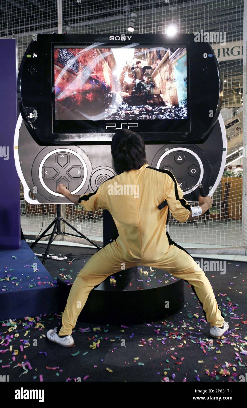 A model dressed as Hong Kong martial arts actor Bruce Lee, poses in ...