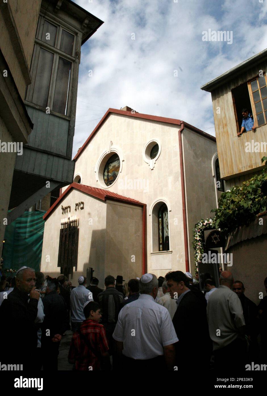 People gather for the opening ceremony of a new synagogue, in the ...