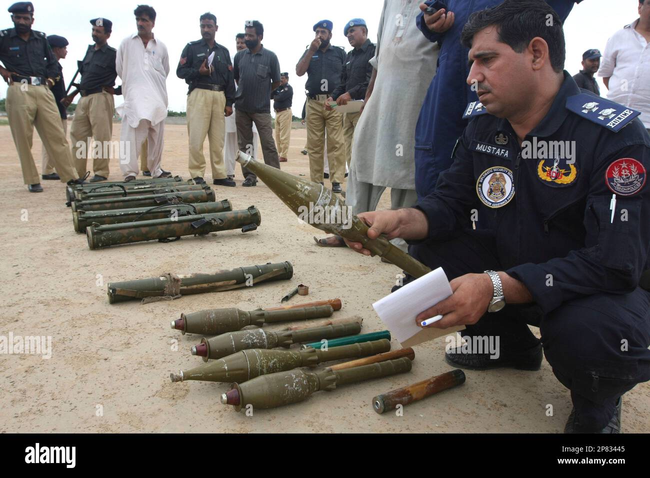 Pakistani police officials examine ammunition allegedly dumped by the ...