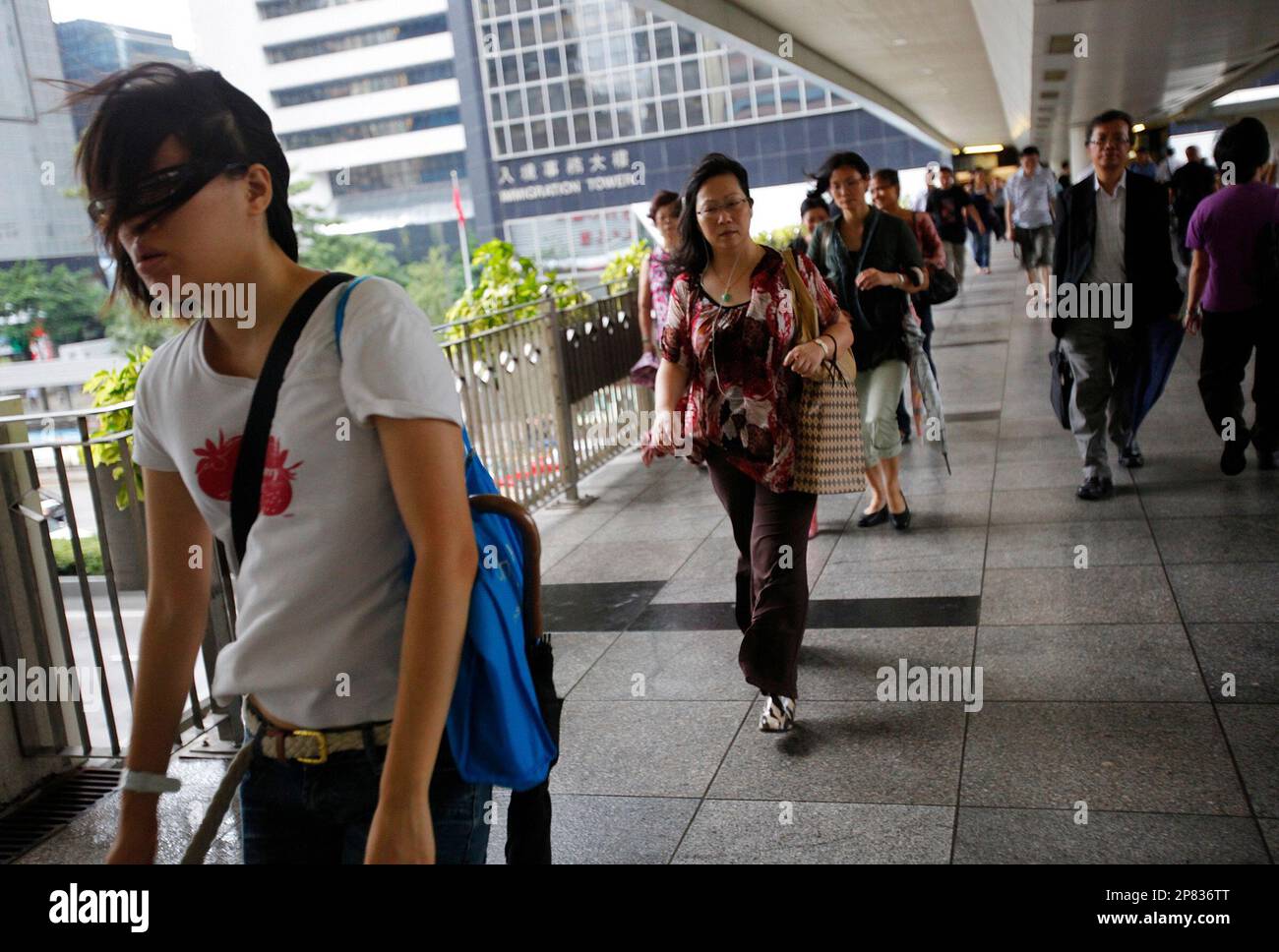 People walk in strong wind in a Hong Kong street Monday, Sept. 14, 2009 ...