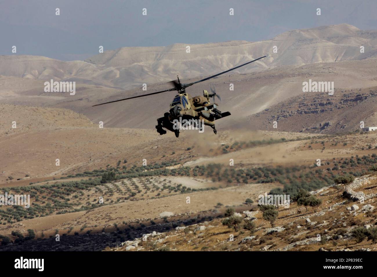 An Israeli air force combat helicopter flies over the area where ...