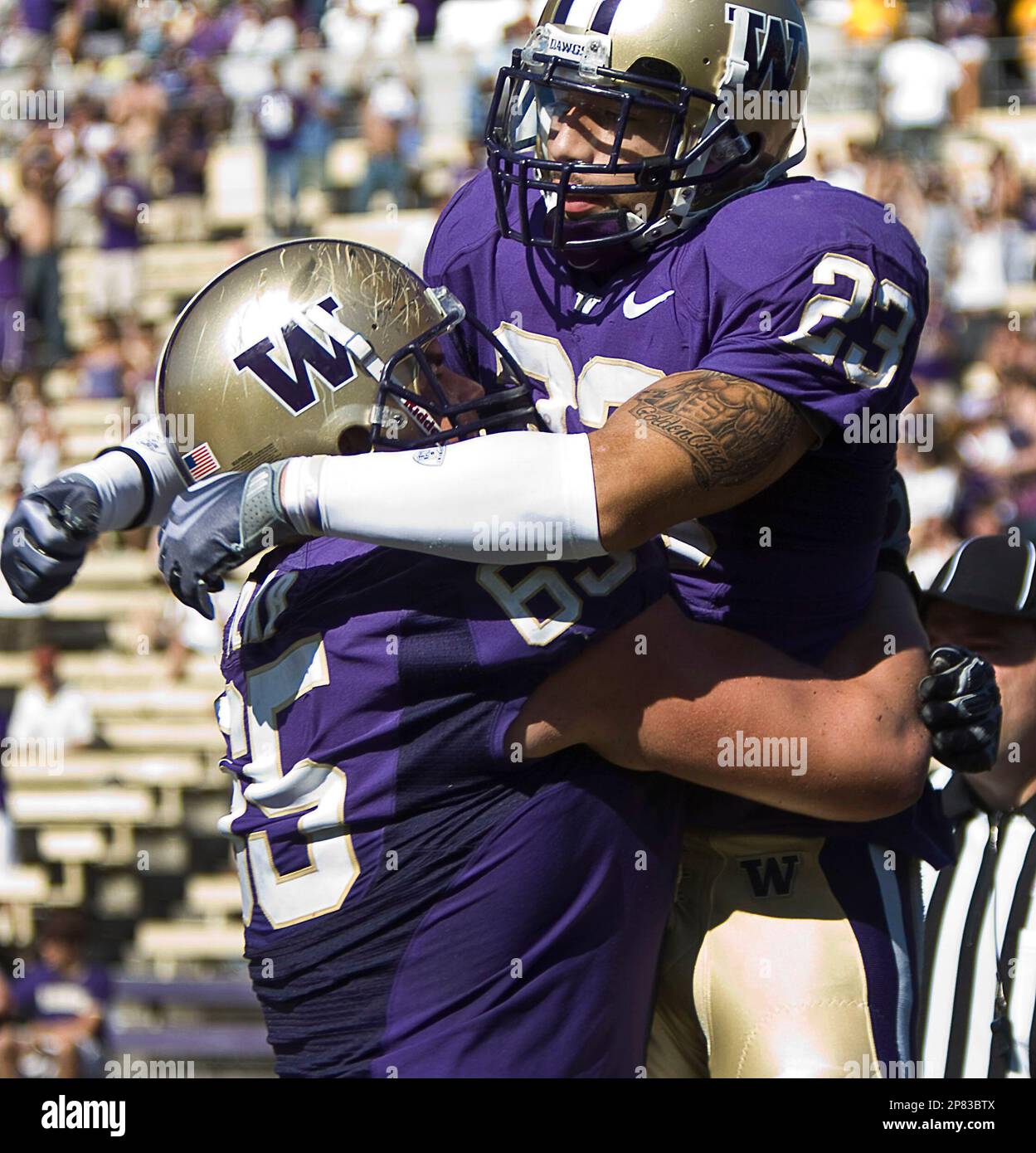 Washington running back Johri Fogerson, right, gets a hug from guard ...