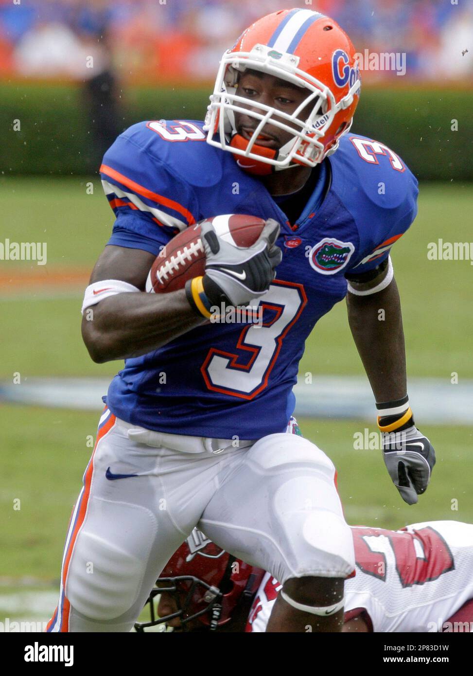 Florida running back Chris Rainey (3) runs past Troy cornerback Bryan ...