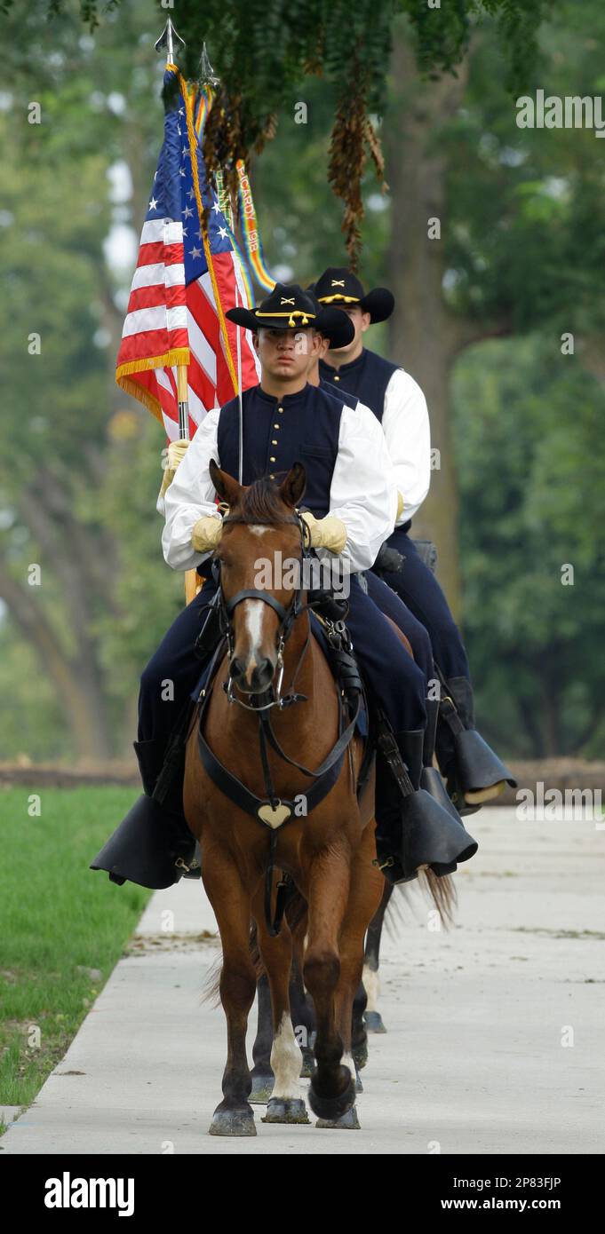 Members of the Commanding General's Mounted Color Guard ride away from ...