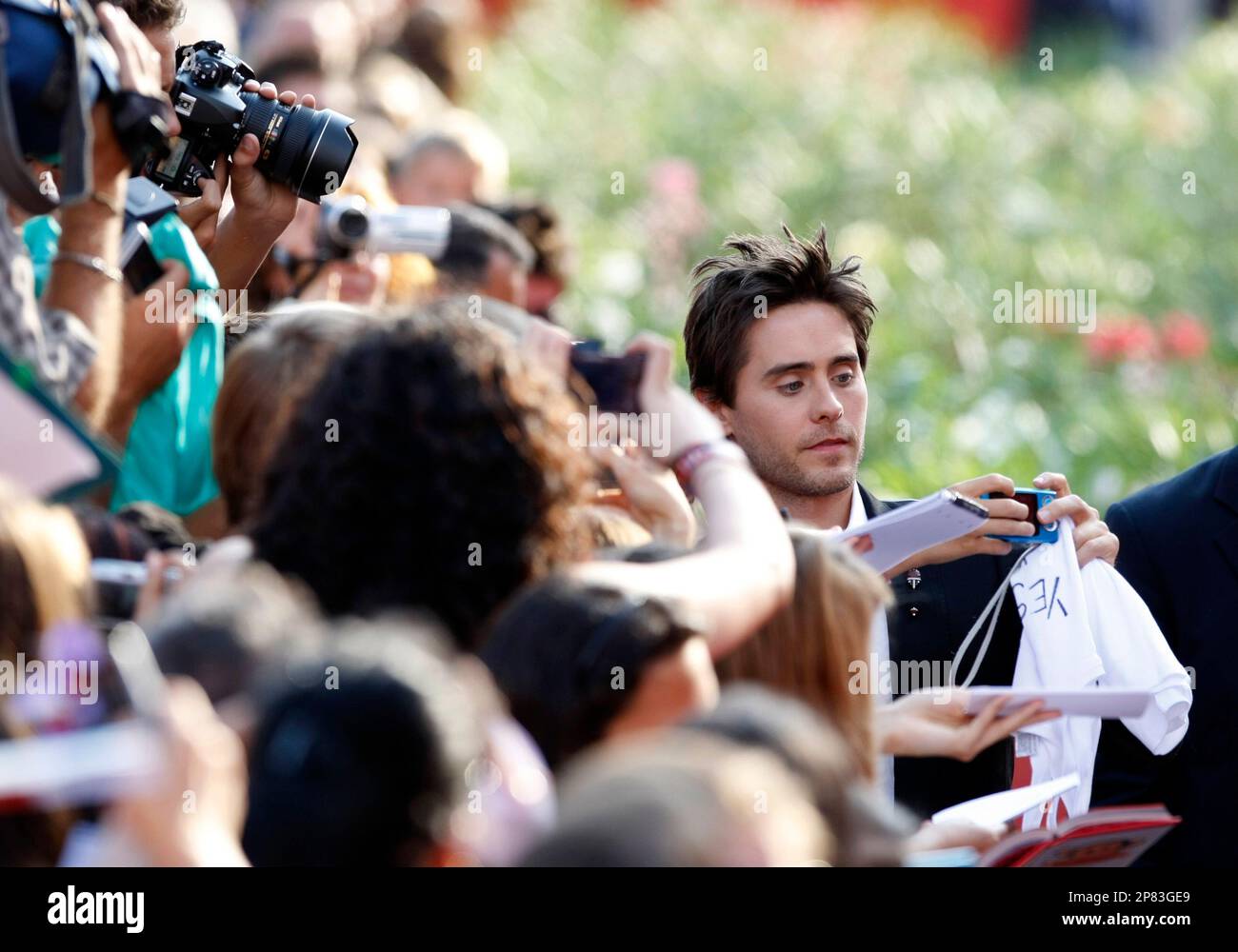 U.S. actor Jared Leto takes a photograph with fans as he arrives at the ...