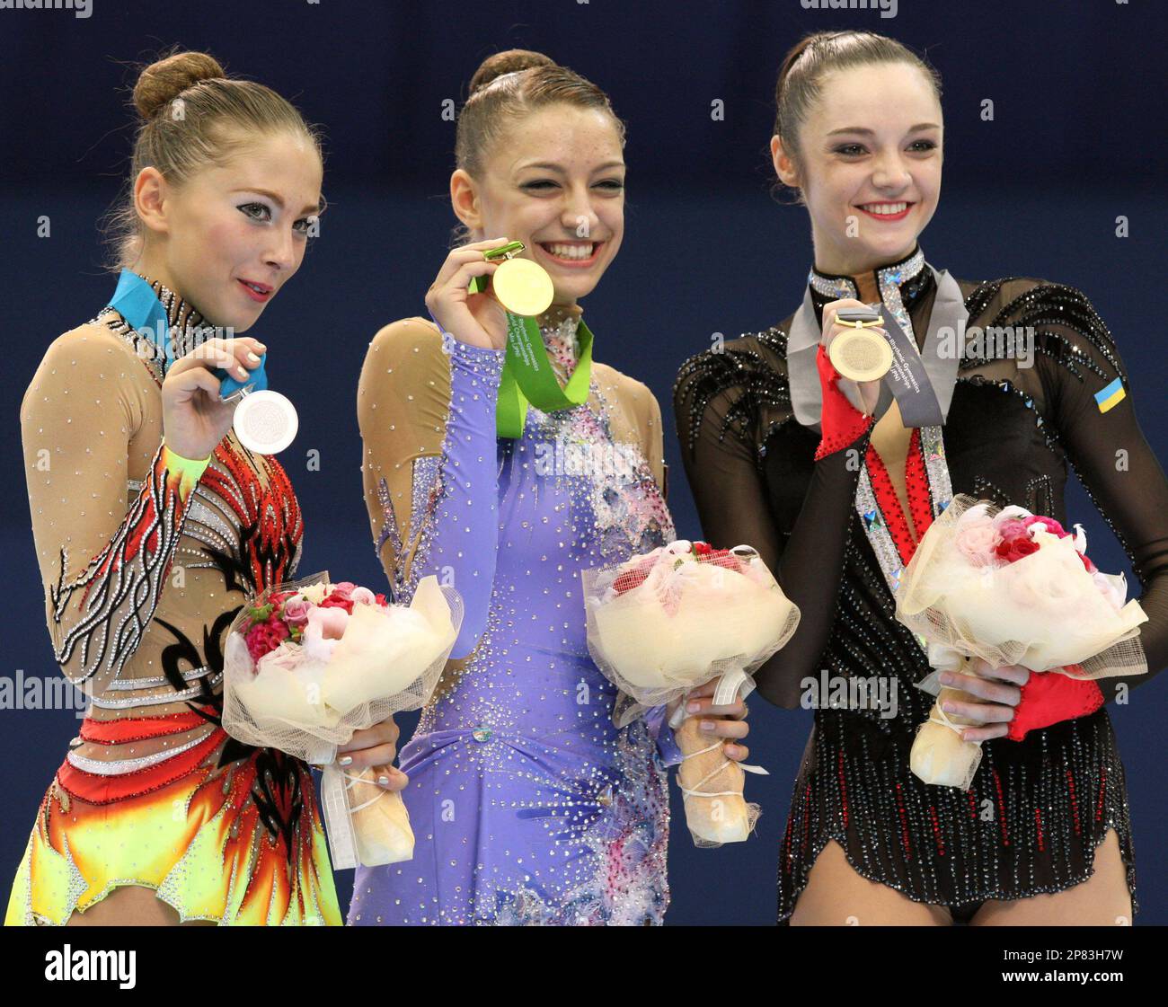Gold medalist Evgeniya Kanaeva, center, silver medalist Daria Kondakova of Russia, left, and ...