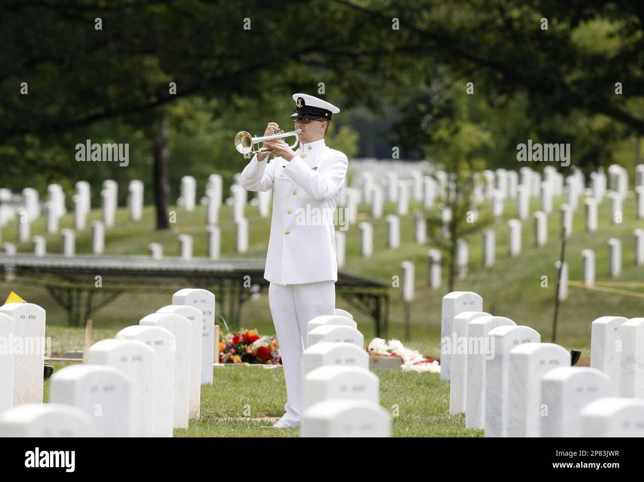 A bugler plays taps during burial services for U.S. Navy Command Master ...