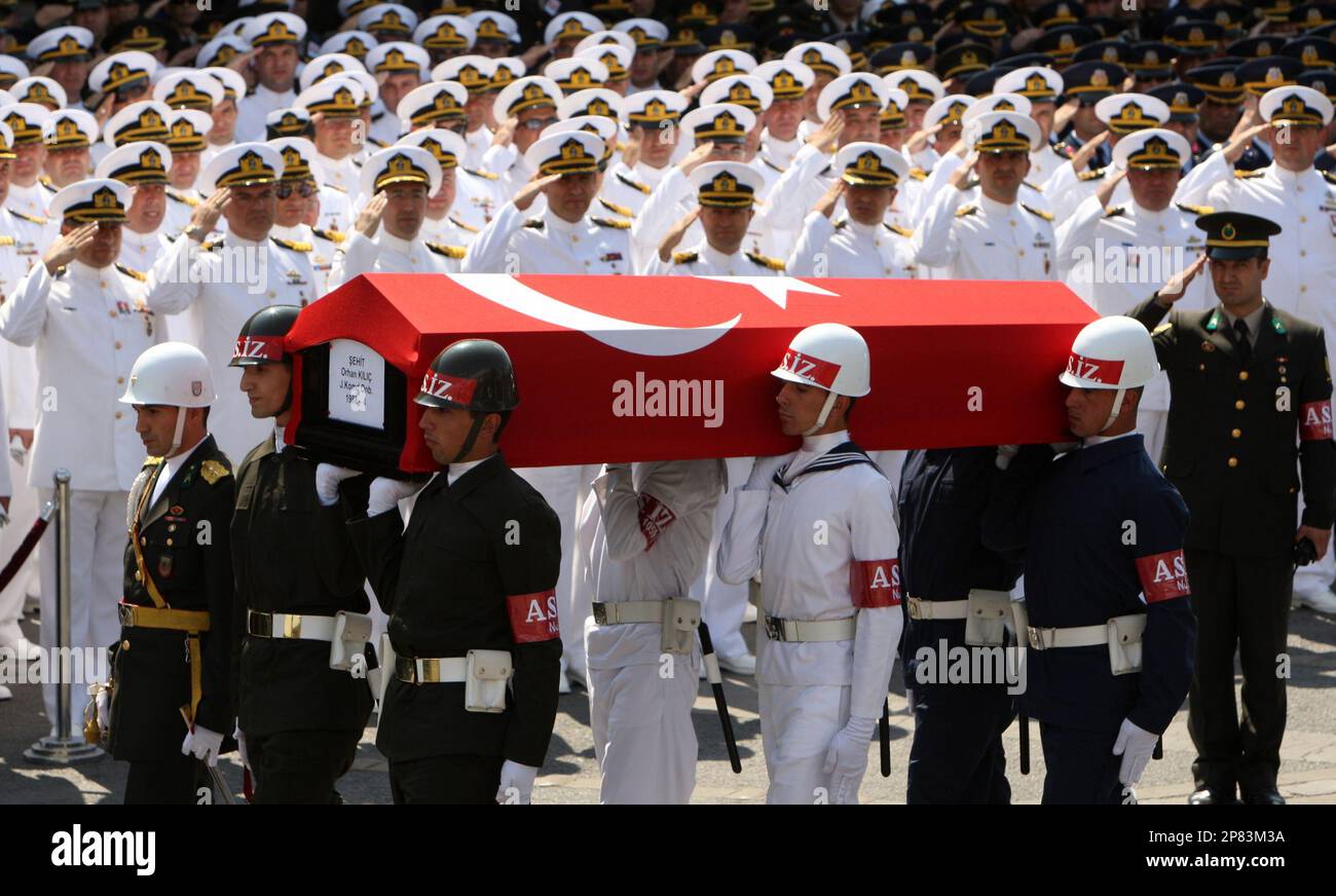 Turkish army officers salute flag-covered coffin of Orhan Kilic, one of ...