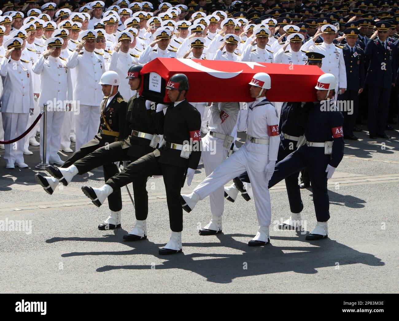 Turkish army officers salute the flag-draped coffin of Orhan Kilic, one ...