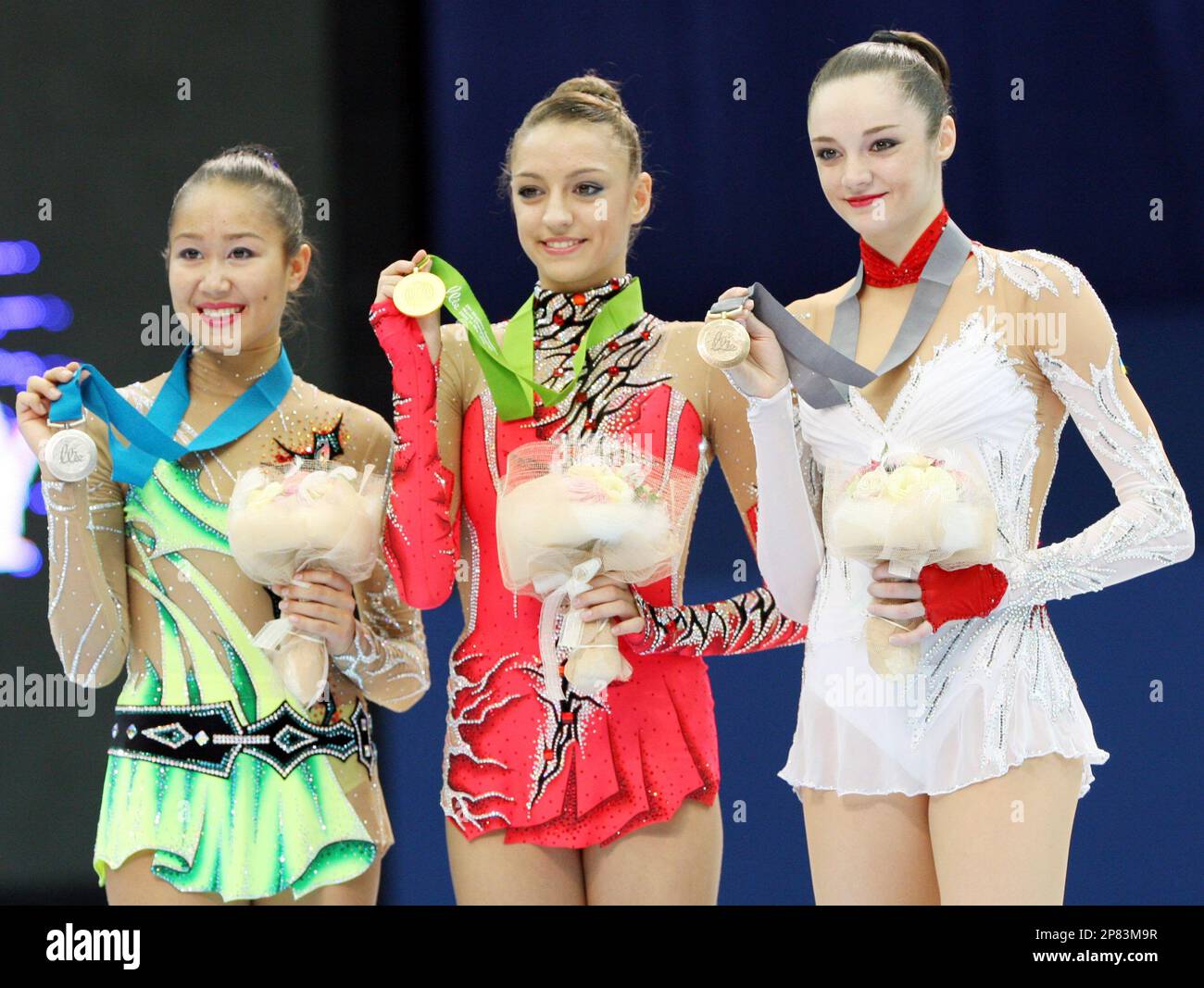 Gold medalist Evgeniya Kanaeva, center, silver medalist Aliya Garayeva ...