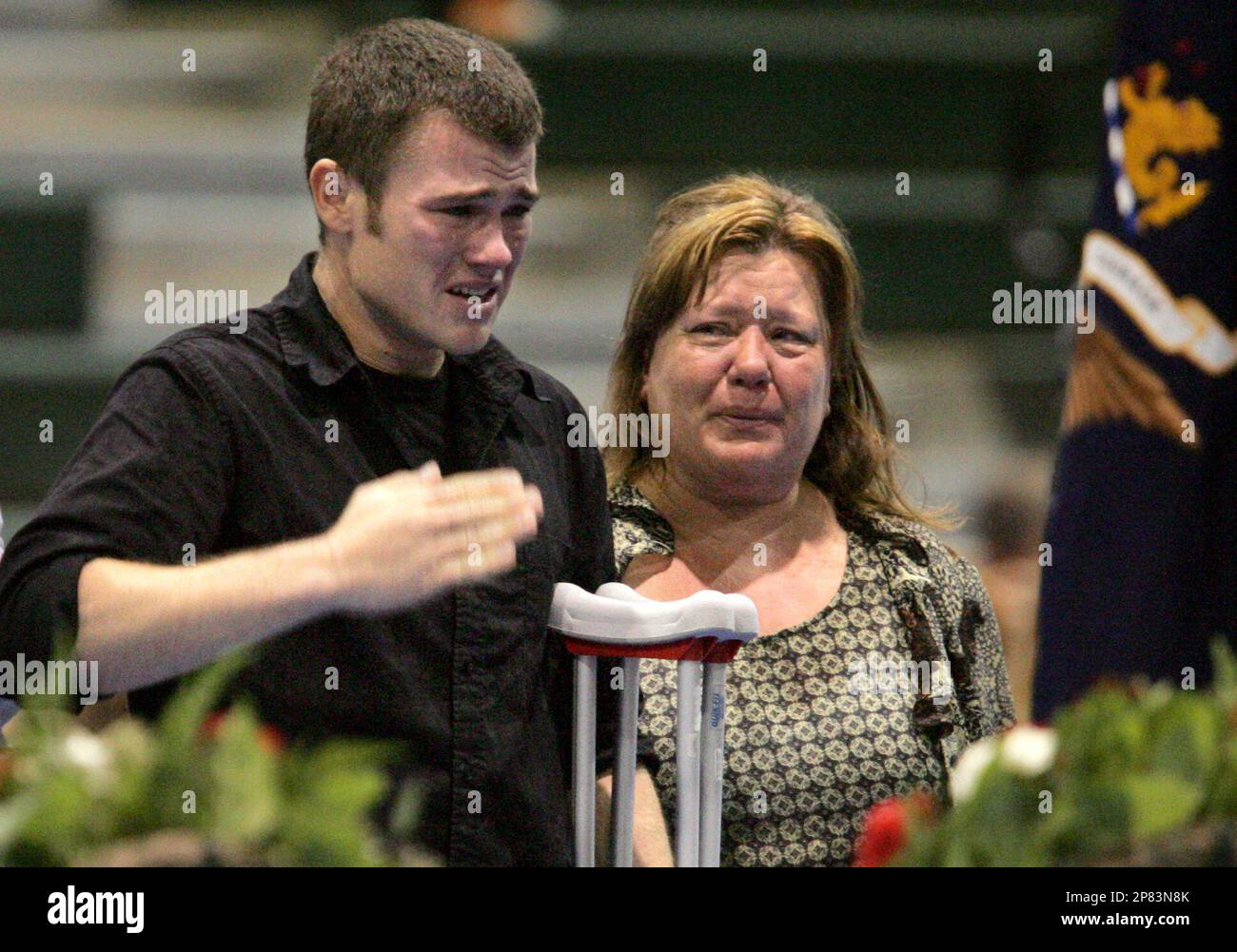 An unidentified mourner salutes the memorial honoring the lives of Capt ...