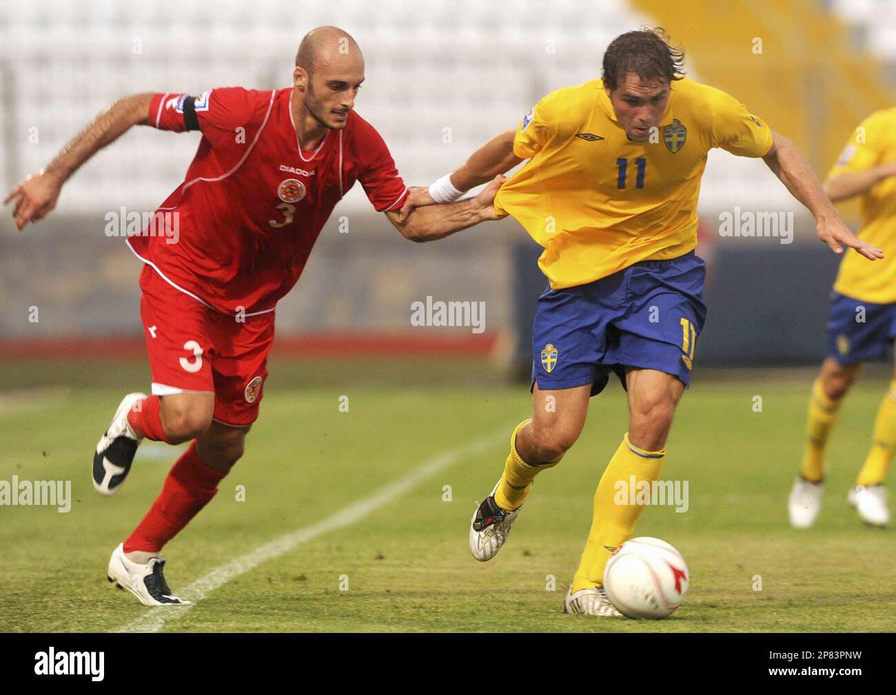 Sweden's Johan Elmander, right, vies for the ball with Malta's Ian ...
