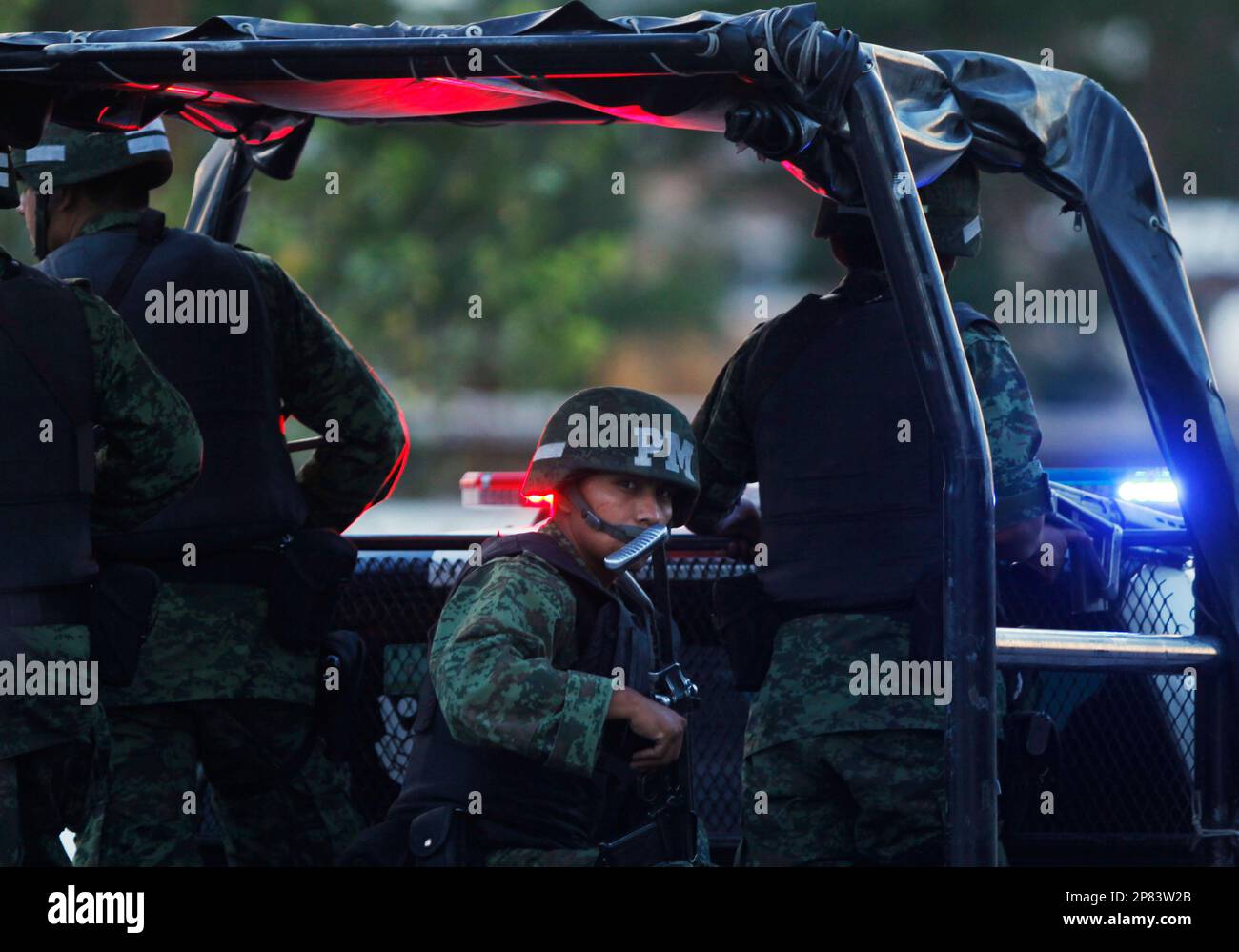 Soldiers patrol next to a crime scene where two men were killed on a ...