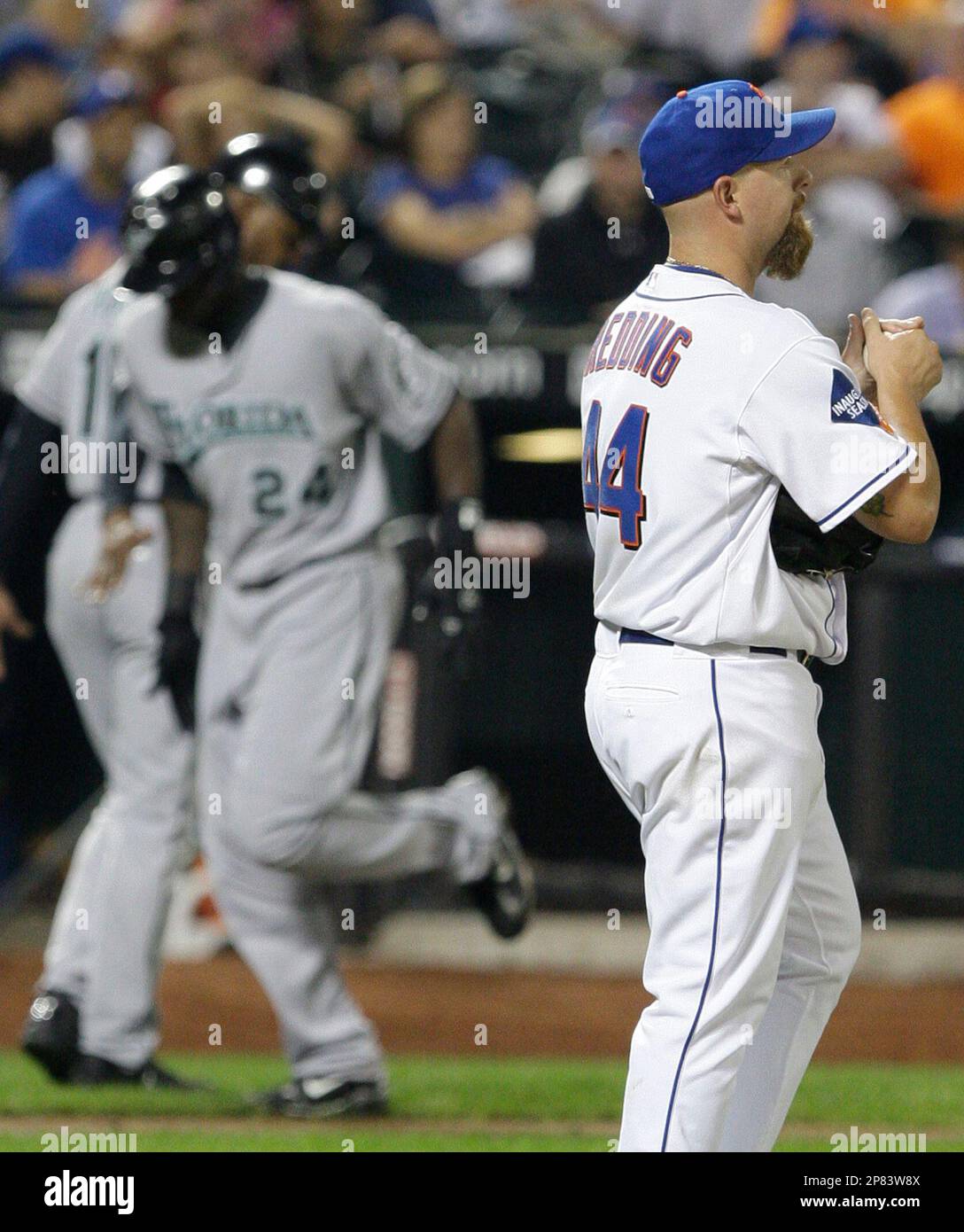 New York Mets starting pitcher Tim Redding rubs up a new baseball as ...